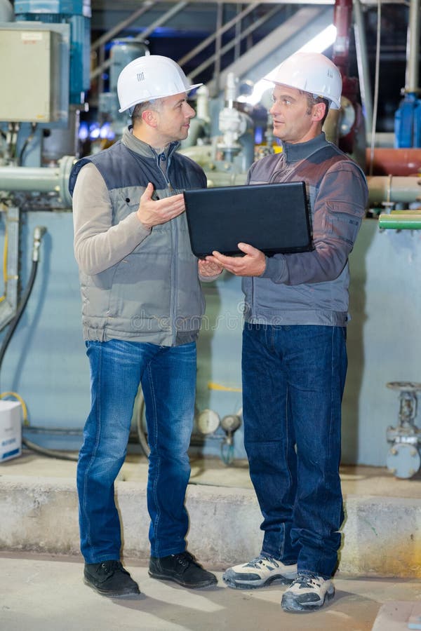 Man with Laptop Presenting Business Project in Factory Stock Image ...
