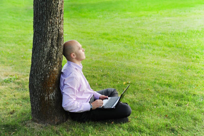 Man with Laptop Sitting Near a Tree Stock Photo - Image of resting ...