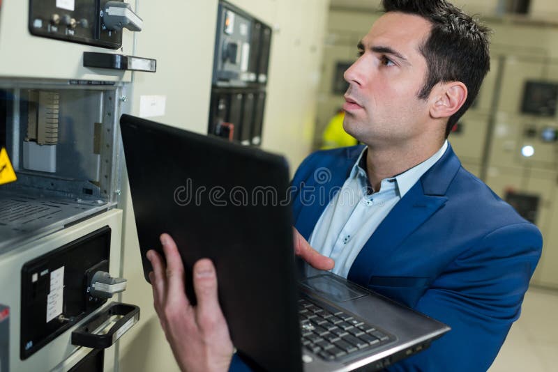 Man with Laptop Standing by Server Cabinet Stock Photo - Image of ...