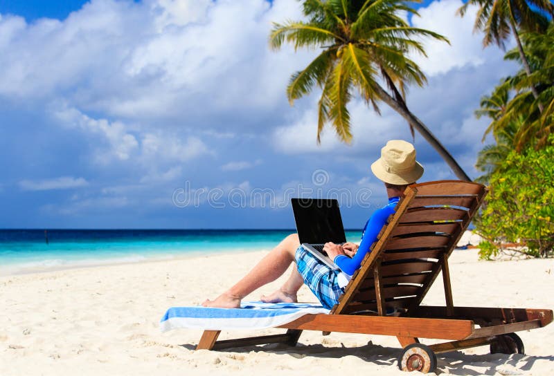 Beach laptop vacation stock image. Image of handsome - 24982105