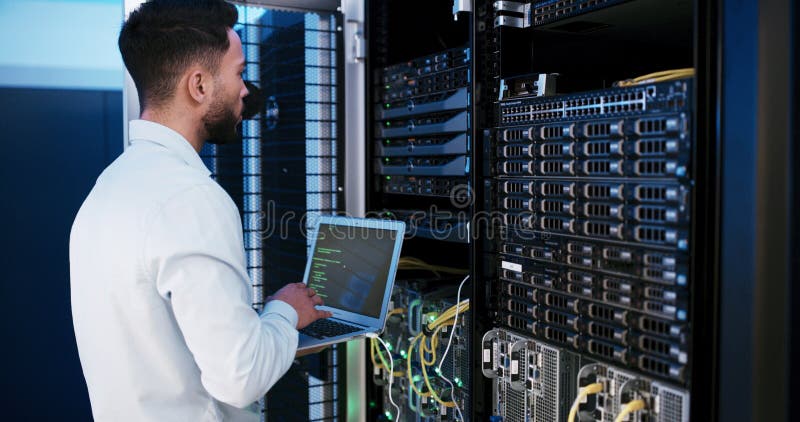 Laptop, Server Room and Black Man on Database Network for Maintenance, Programming Software or ...