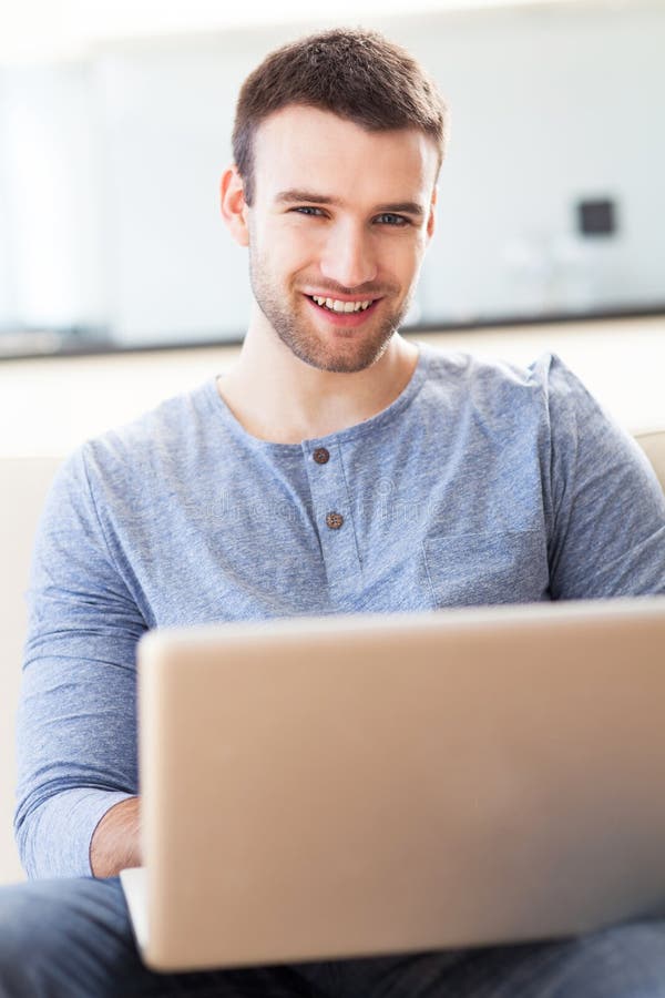 Smiling Guy Using Laptop Computer Stock Photo - Image of adult, indoors ...