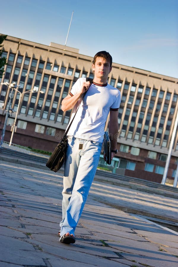 Man with Laptop Walking Along the Street Stock Image - Image of ...