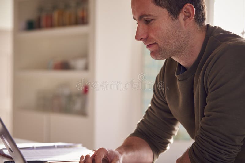 Man with Laptop Working from Home on Kitchen Counter Stock Image ...