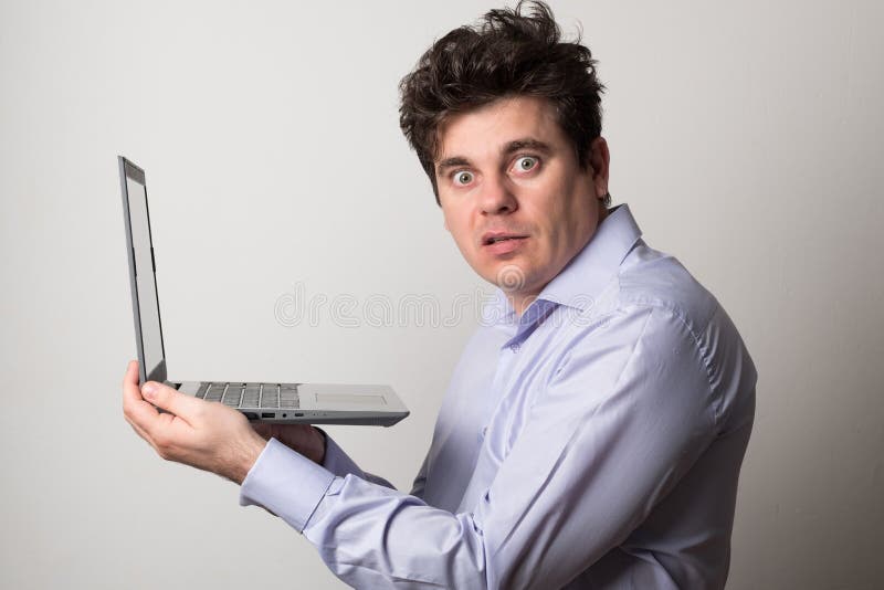 Man with a Laptop. Young Man Works on the Laptop Remotely Stock Photo ...