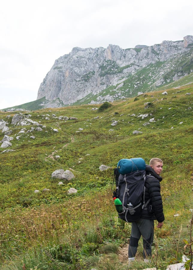 Man with a large backpack stock image. Image of grass - 77012565