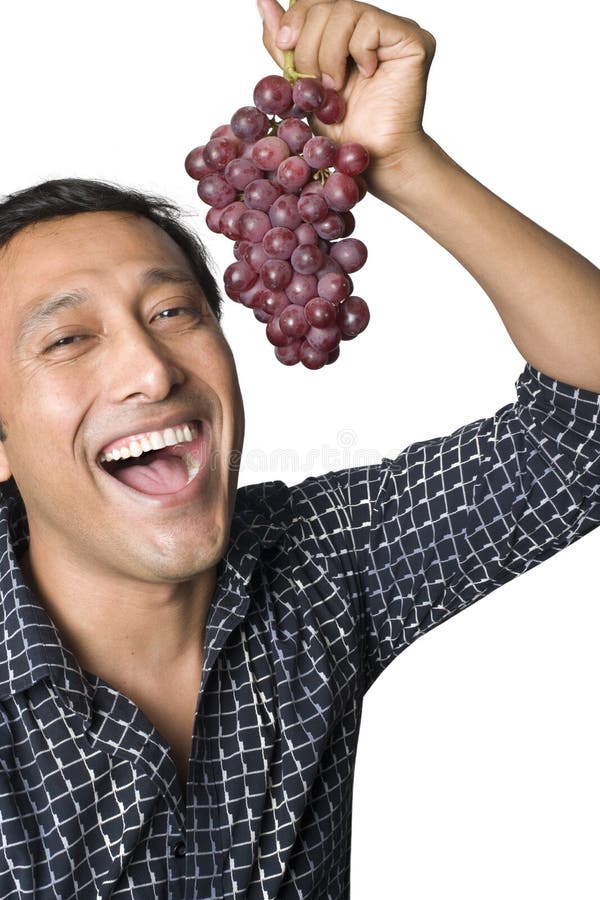Man Laughing and Eating Grapes Stock Photo - Image of latino, funny ...