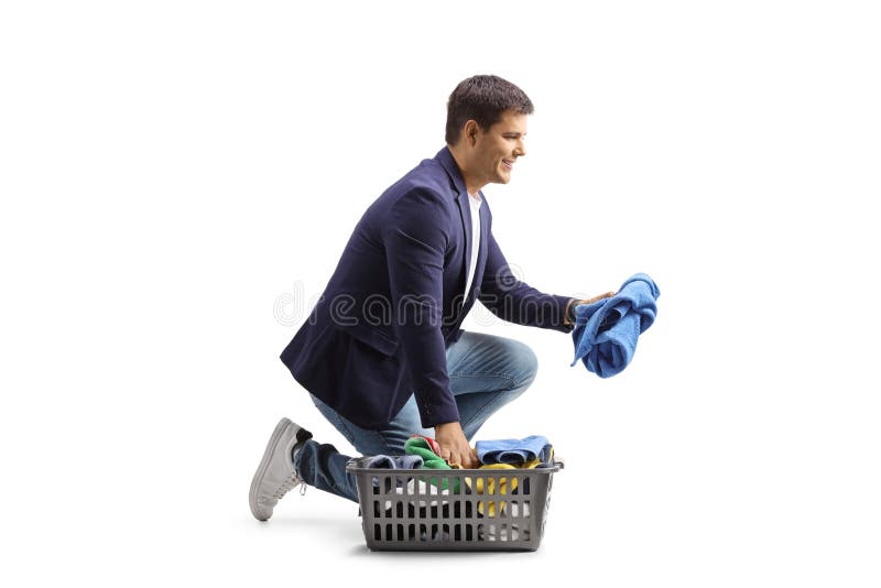 Man with a Laundry Basket Kneeling and Sorting Clothes Stock Photo ...