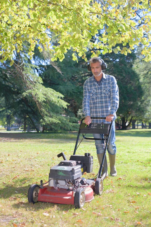 Man with lawn mower stock photo. Image of horticulture - 123593260