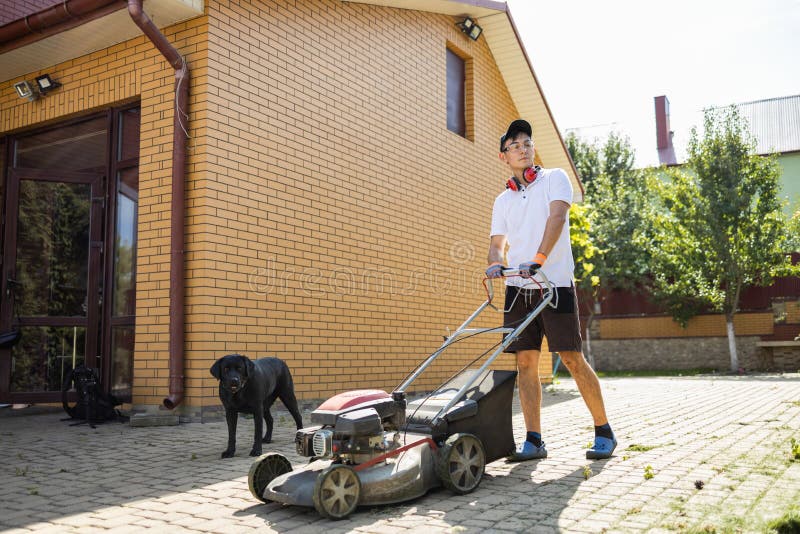 Man with Lawn Mower Near the House. Stock Photo - Image of lawnmower ...