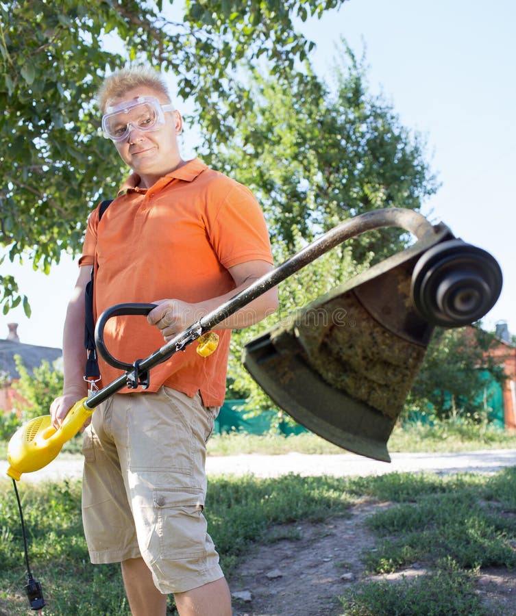 Man with a lawn mower stock image. Image of motor, tool - 43801403