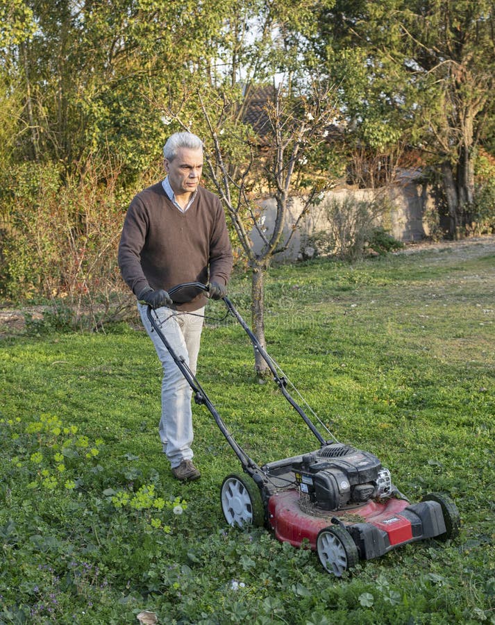 Man with lawnmower stock image. Image of grass, gardener - 180617693