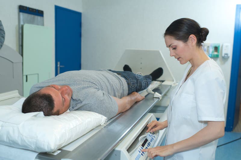 Man lay on x-ray table stock photo. Image of room, vertical - 150199006