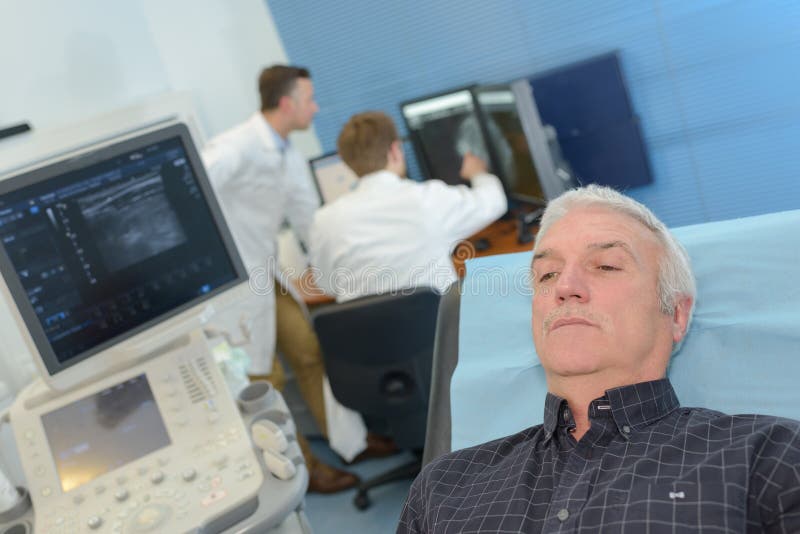 Man Layed on Hospital Bed Next To Scanner Equipment Stock Image - Image ...