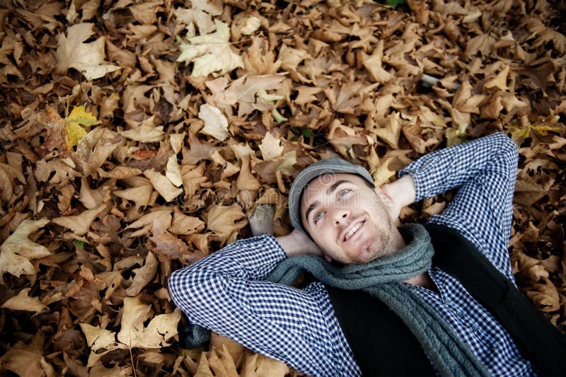 Man Laying on Autumn Leaves. Stock Photo - Image of carefree, happy ...