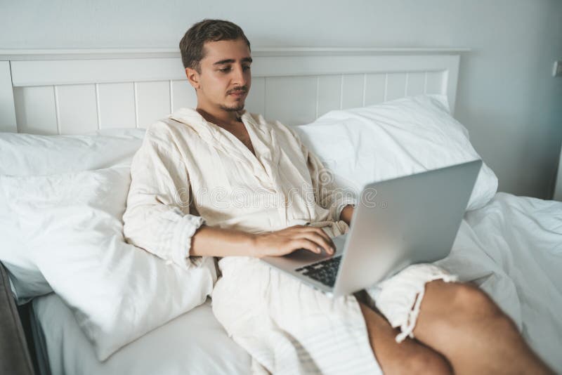 Man Laying in Bed and Working on Laptop Stock Image - Image of bathrobe ...
