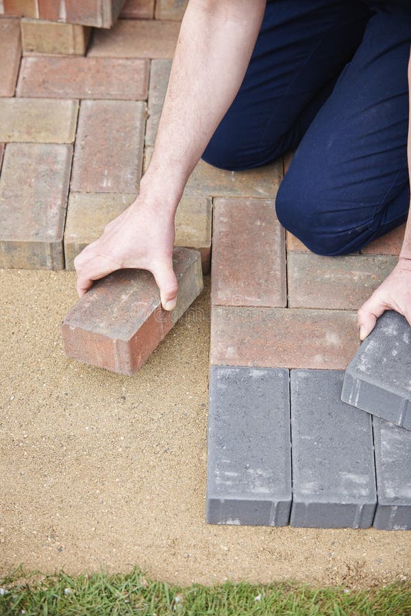Man Laying Blocks for Patio Stock Photo - Image of brick, construction ...
