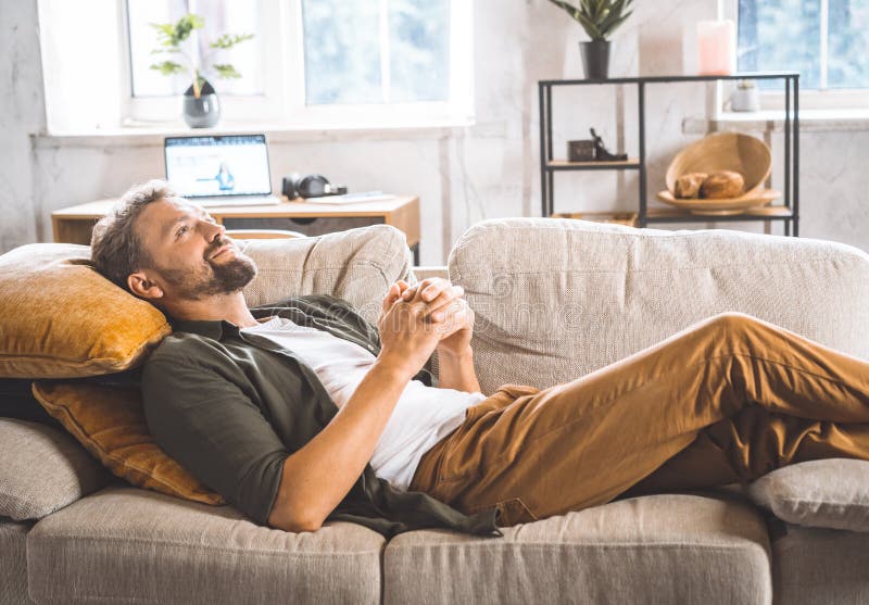 Man Relaxing on Couch with Pillow Stock Photo - Image of recline ...