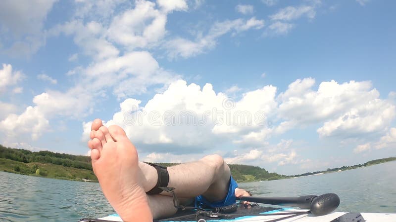 Man Laying Down on Supboard Sunbathing Stock Video - Video of beautiful ...