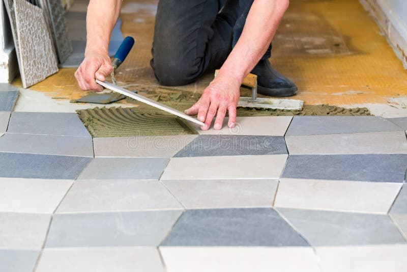 Man laying floor tiles stock image. Image of shapes, interior - 98125161