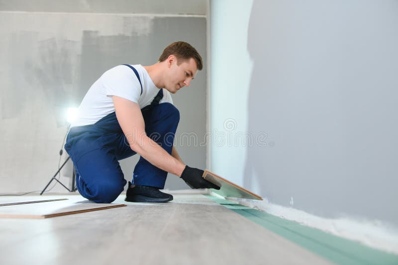 Man Laying Laminate Flooring in Construction Concept Stock Image ...