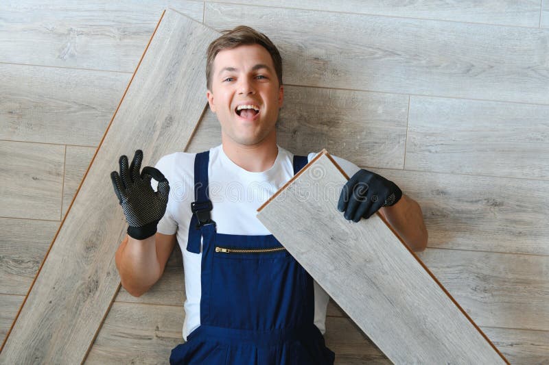 Man Laying Laminate Flooring in Construction Concept Stock Image ...