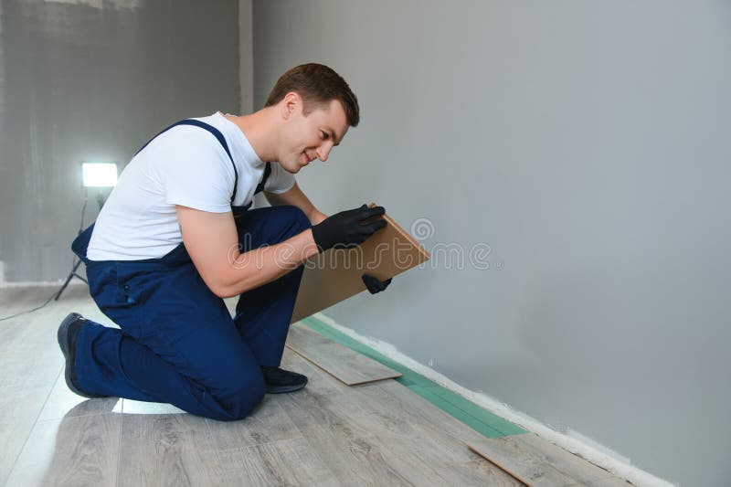 Man Laying Laminate Flooring in Construction Concept Stock Image ...