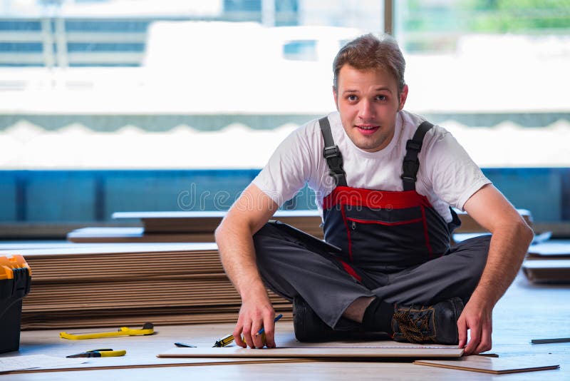 The Man Laying Laminate Flooring in Construction Concept Stock Photo ...