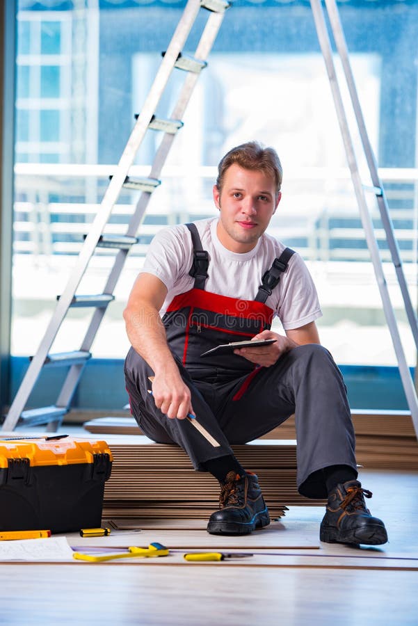 The Man Laying Laminate Flooring in Construction Concept Stock Photo ...