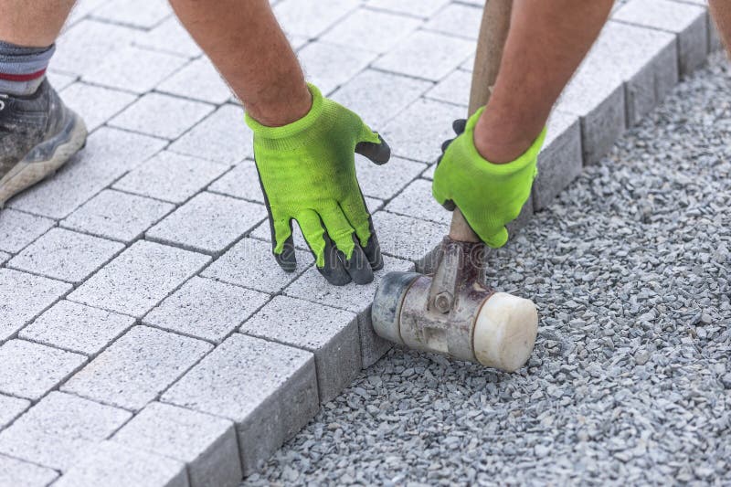 Man Laying Paving Tiles on the Floor Using a Rubber Mallet Stock Photo ...