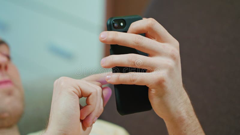 Man Laying on the Sofa and Using Mobile Phone Stock Photo - Image of ...