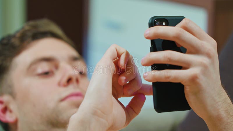 Man Laying on the Sofa and Using Mobile Phone Stock Image - Image of ...
