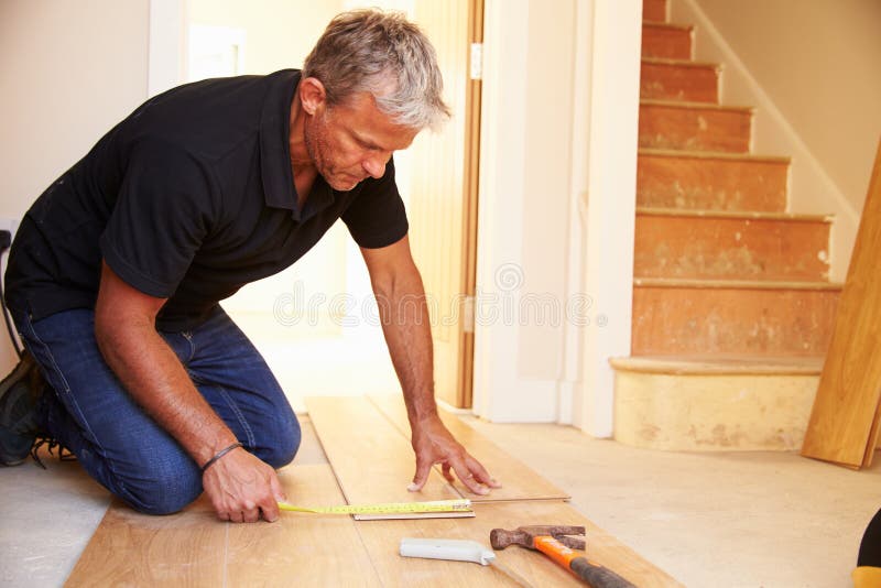 Man Laying Wood Panel Flooring during a House Refurbishment Stock Photo ...
