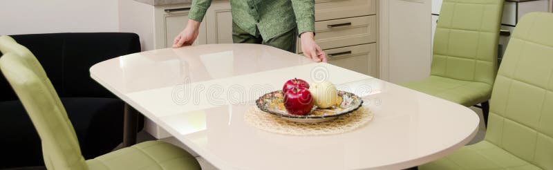 Man Lays Out a Sliding Glossy Dining Table on Which Stands a Plate with ...