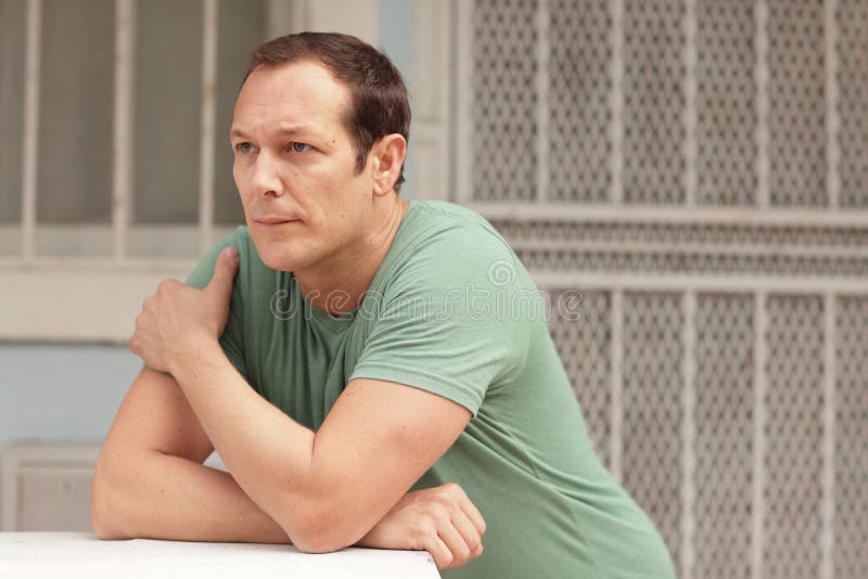 Man leaning on the ledge stock photo. Image of color - 19262022