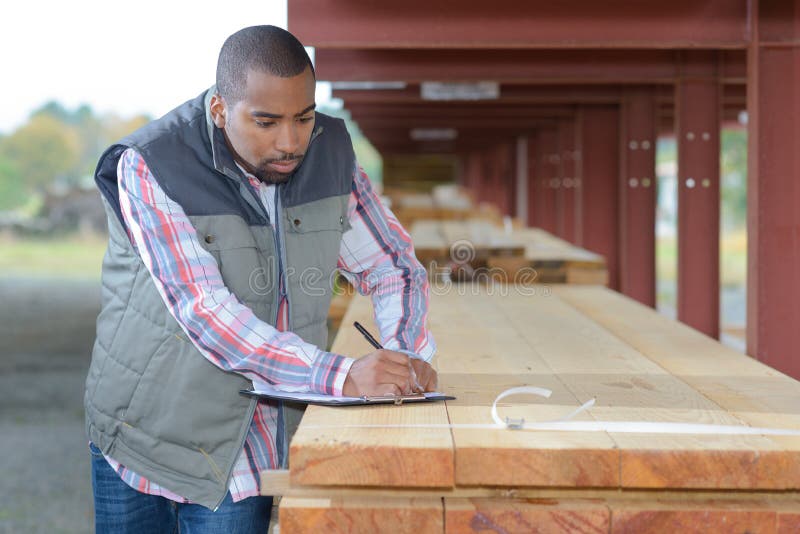 Man Leaning on Stack Wood To Write Notes Stock Image - Image of ...