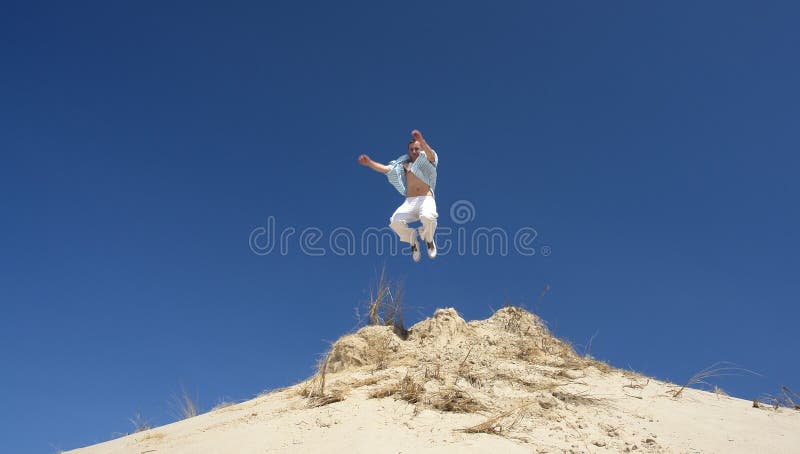 Man Leaping on Hilltop stock photo. Image of sunshine - 2372388