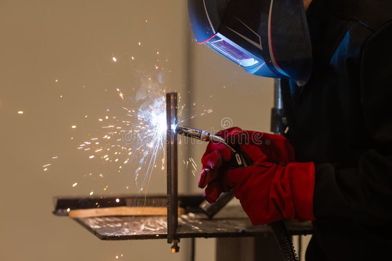 A Man Learns the Craft of Welding on a Sample. Stock Image - Image of ...