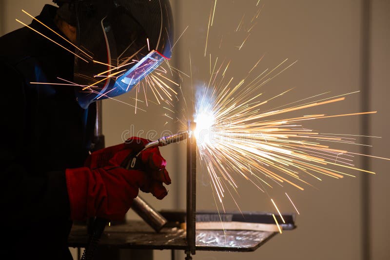A Man Learns the Craft of Welding on a Sample. Stock Photo - Image of ...