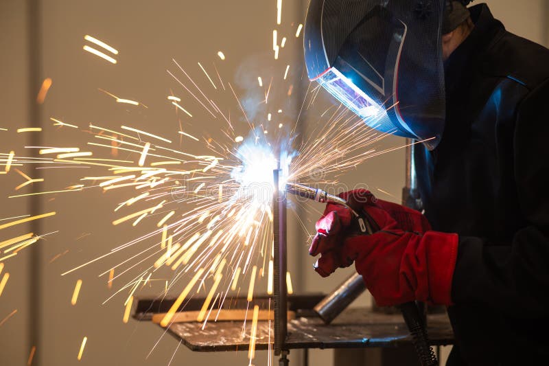 A Man Learns the Craft of Welding on a Sample. Stock Image - Image of ...