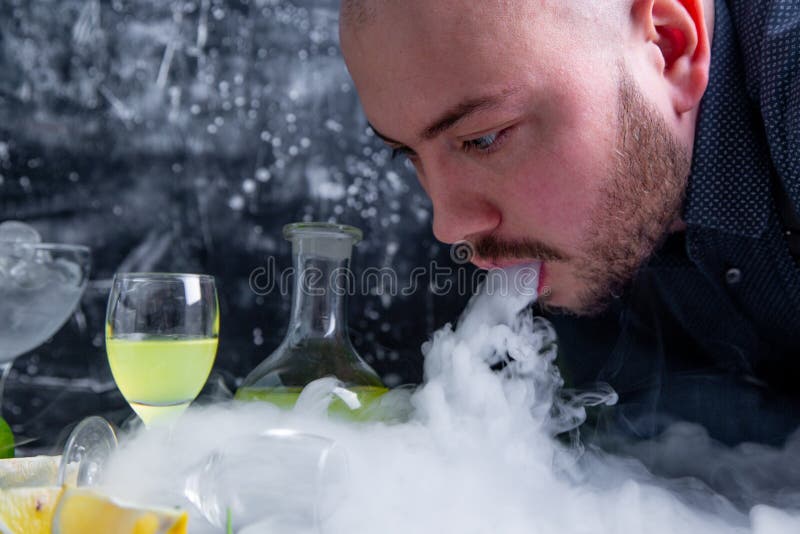 Man Lets Out Steam from a Mouth on a Table Served with Limoncello Stock ...