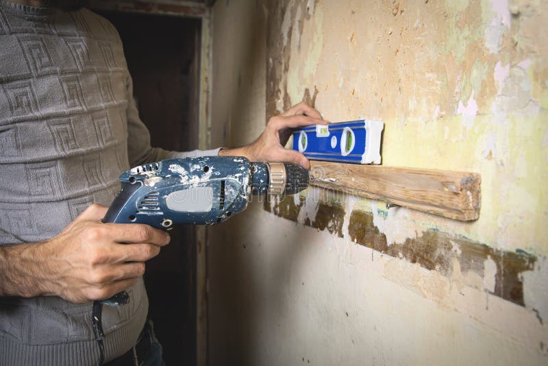 Man with Level Checking the Level of a Plank of Wood Stock Image ...