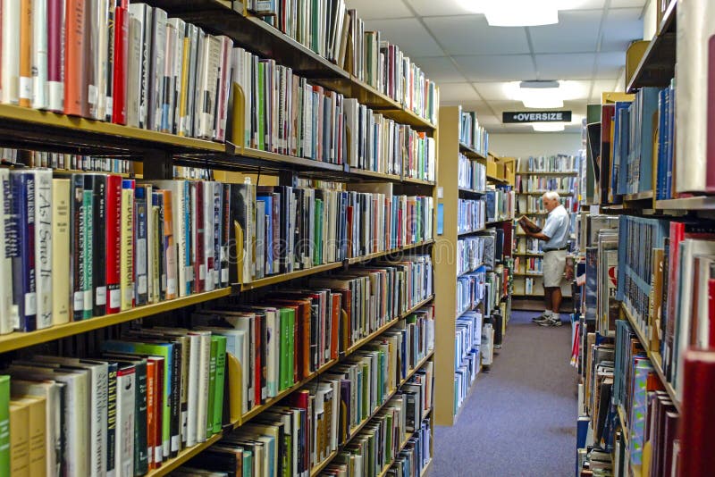 A Man in a Library Searching for a Book Editorial Stock Image - Image ...