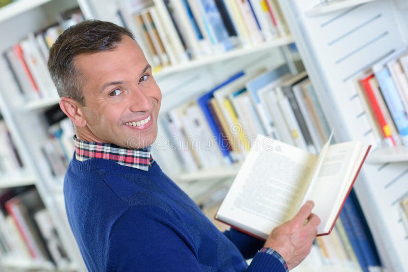 Man in Library Turning and Smiling Stock Photo - Image of smile ...