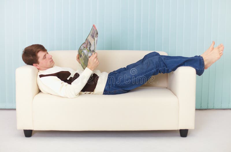 Person Comfortably Lie on Sofa with Journal Stock Photo - Image of ...