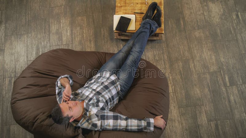The Man Lies on a Sofa and Talking on the Phone. Stock Image - Image of ...