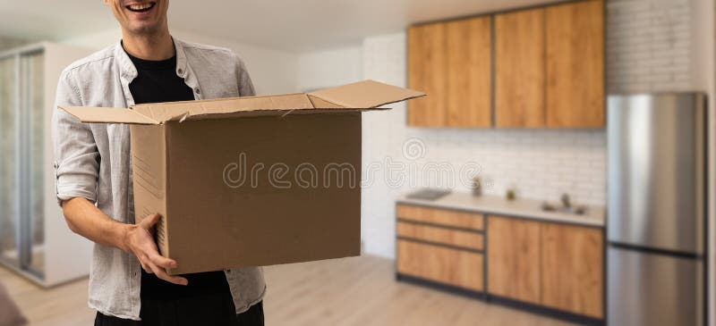 Man Lifting Cardboard Boxes in Apartment Interior. Stock Photo - Image ...