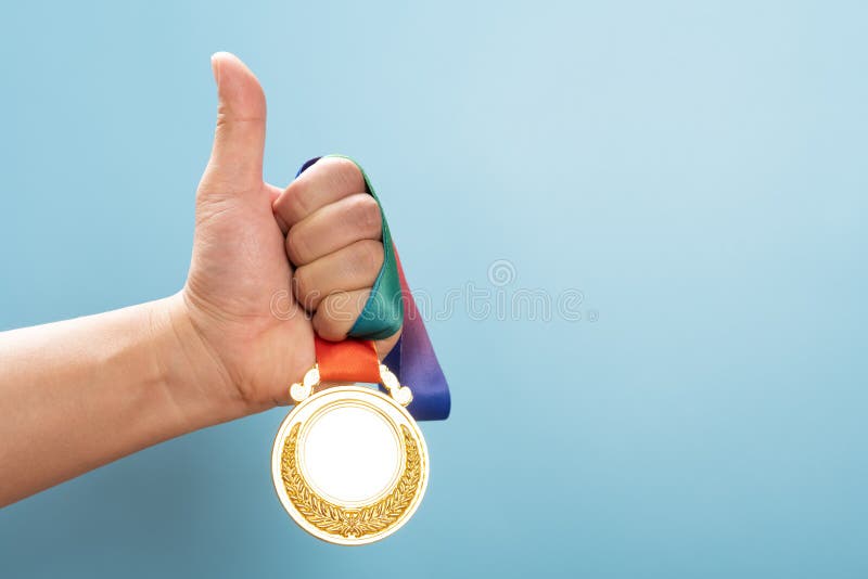 A Man Lifting a Gold Medal with the Thumb Up Stock Image - Image of ...