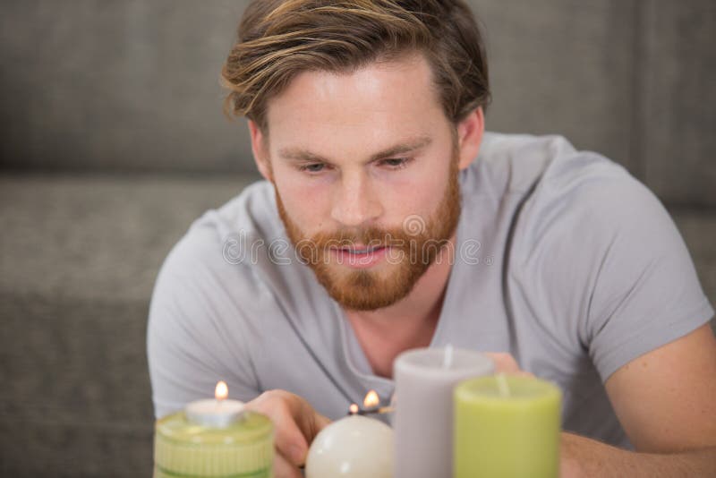 Man Lighting Candles in Home Stock Photo - Image of scented, twenties ...