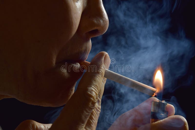 A man lighting a cigarette stock image. Image of fire - 96723835